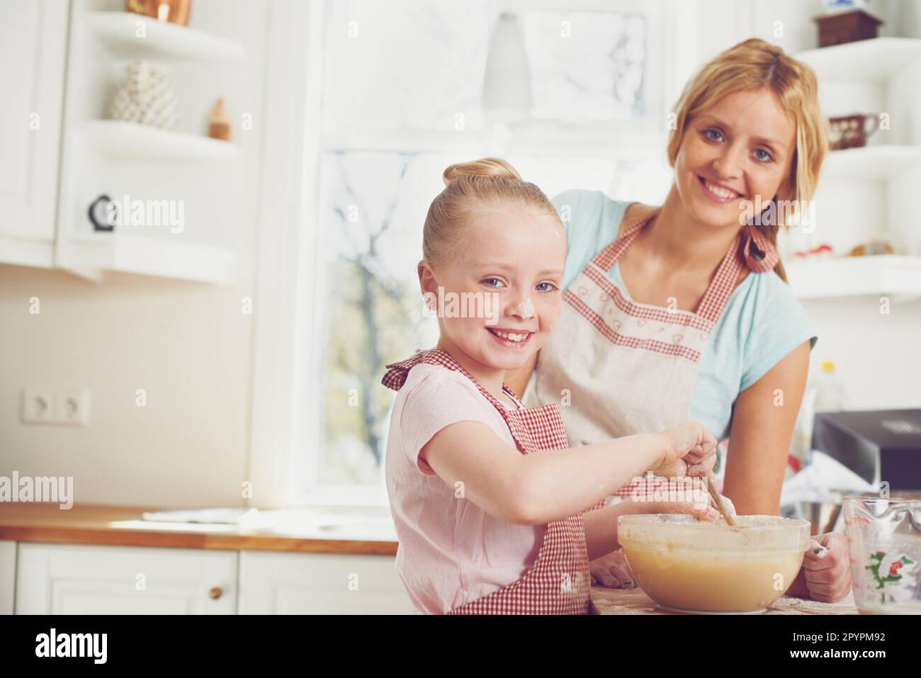 Baking together is the best. Cute little girl baking in the kitchen ...