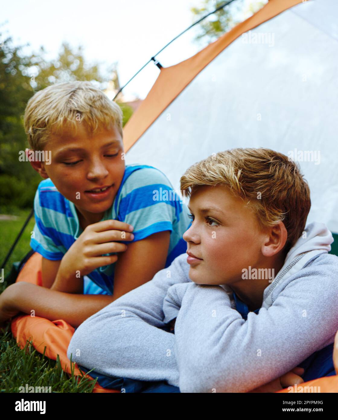 Camping rest and relaxation. three young boys lying in their tent Stock ...