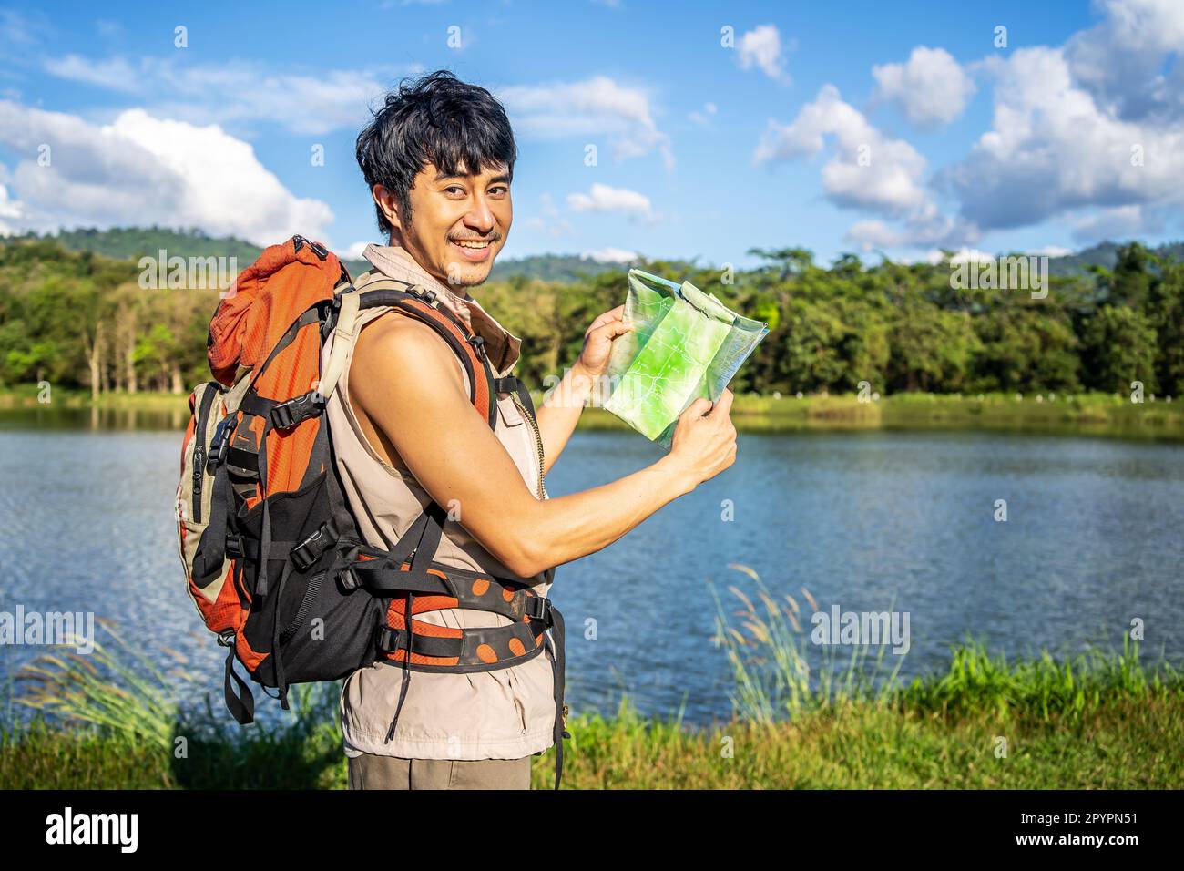 Young asian attractive male tourists looking for map in forest, Lost ...