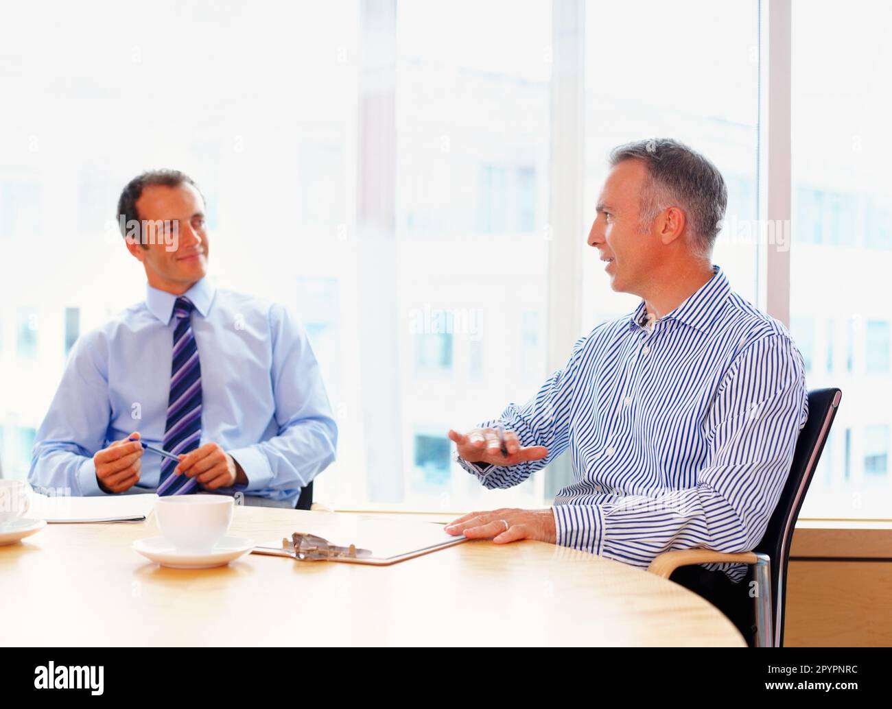 Executives brainstorming ideas. Colleagues indoors having discussion ...