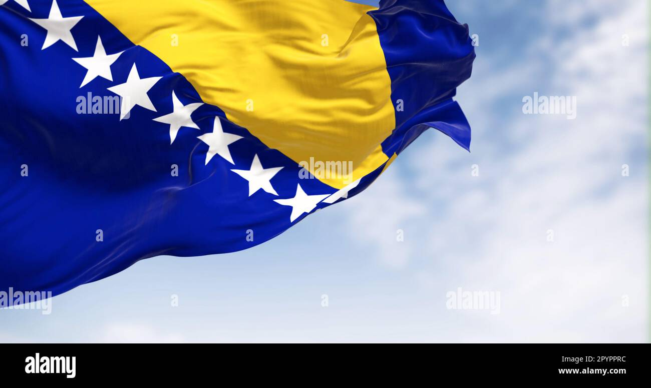 Flag of Bosnia and Herzegovina waving in the wind. Blue field with ...