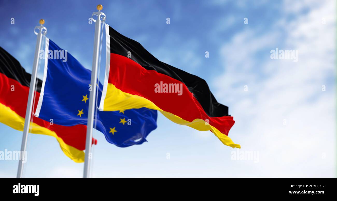 The flags of Germany and the European Union waving together on a clear ...