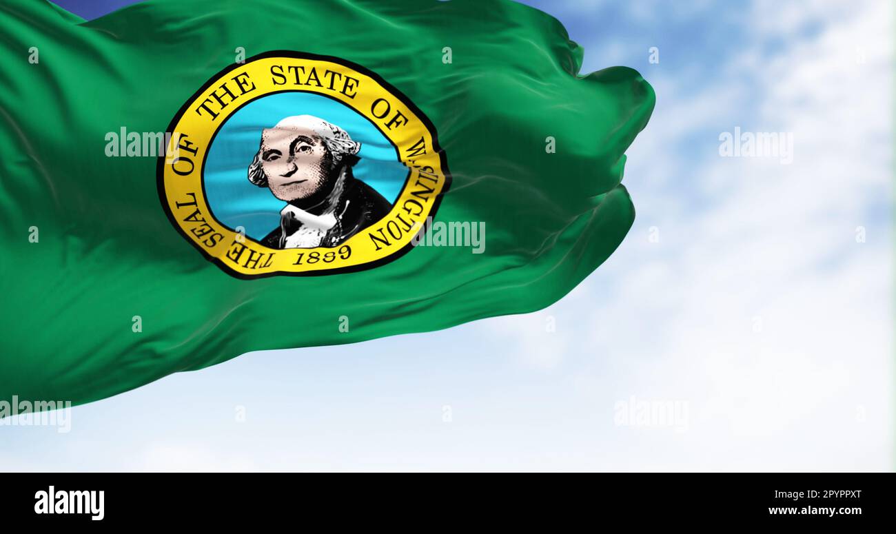 The flag state of Washington waving in the wind on a clear day. Green ...