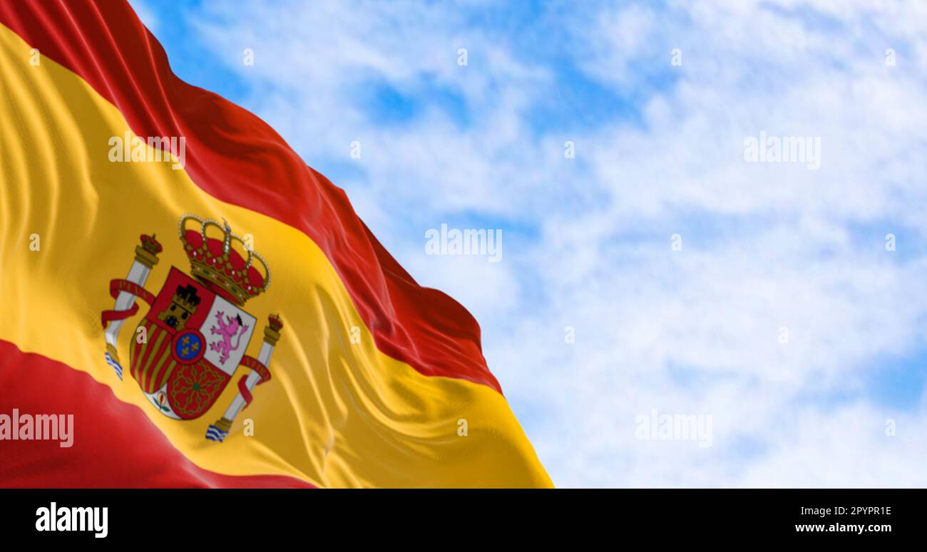 The national flag of Spain waving in the wind in a clear day. European ...