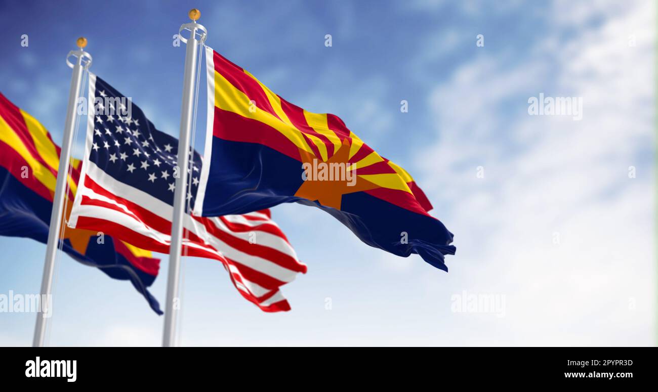 The flags of Arizona and United States waving in the wind on a clear ...