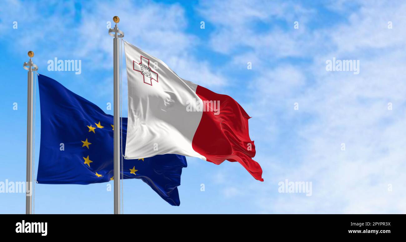The flags of Malta and the European Union waving in the wind on a clear ...