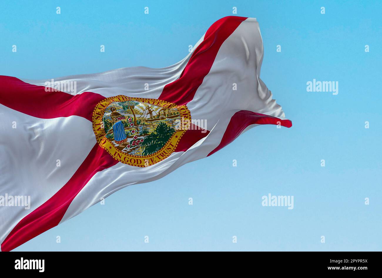 Close-up view of the Florida state flag waving in the wind on a clear ...