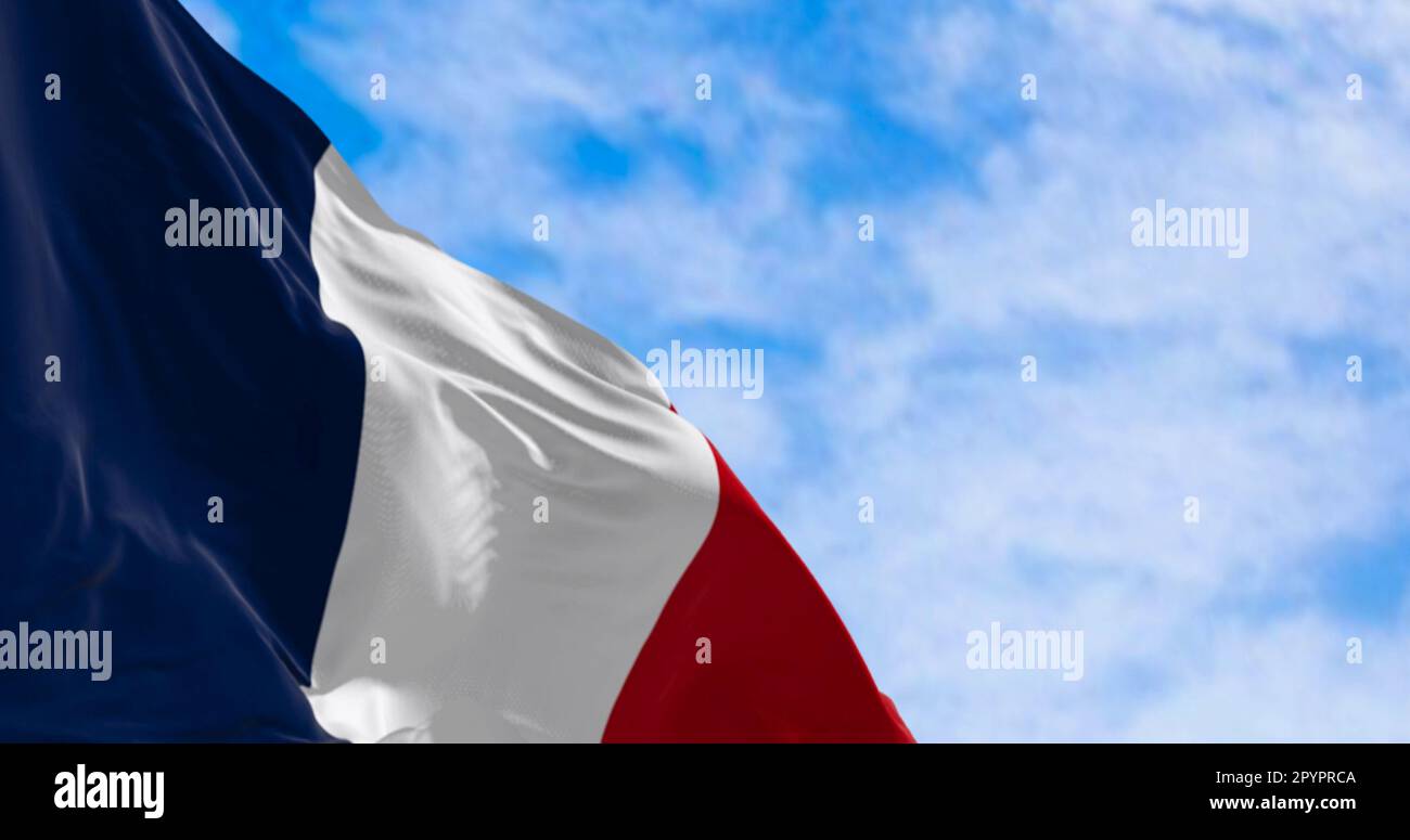The national flag of France waving in the wind on a clear day. Tricolor ...