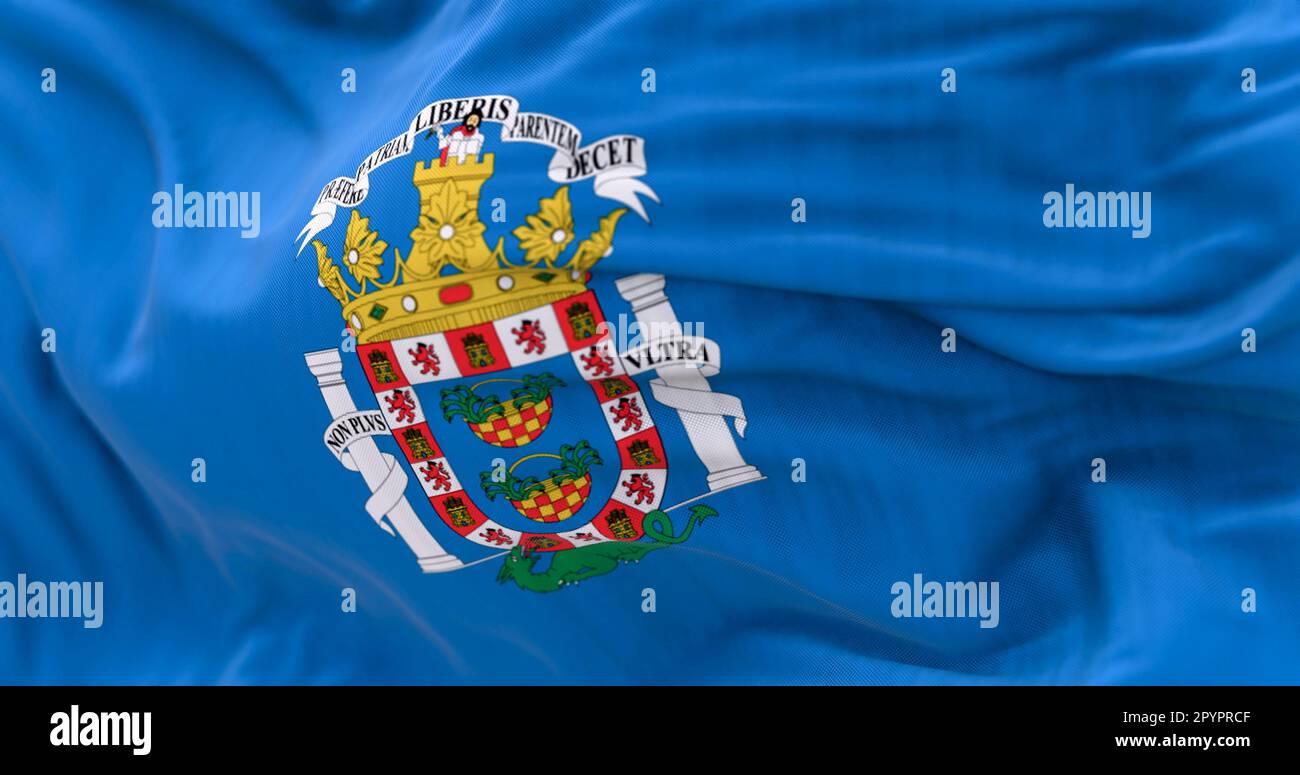 Detail of the Melilla flag waving. Autonomous city of Spain. Pale blue ...