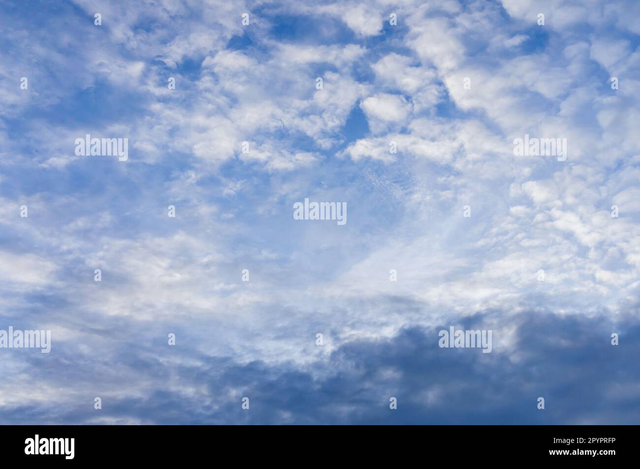 A mixture of white fluffy and puffy clouds against the blue sky in the ...