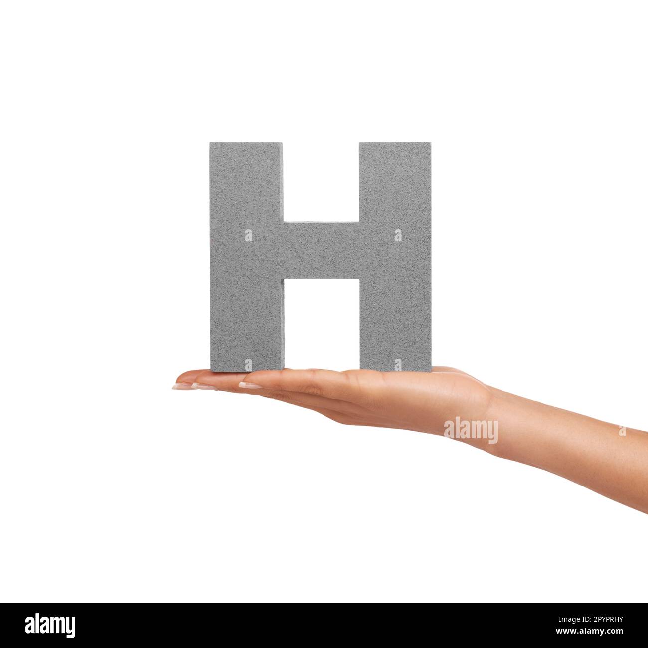Here is the letter H. A young woman holding a capital letter H isolated ...