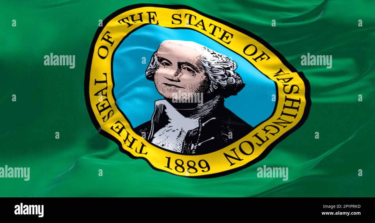 Close-up of the Washington state flag waving in the wind. Green field ...