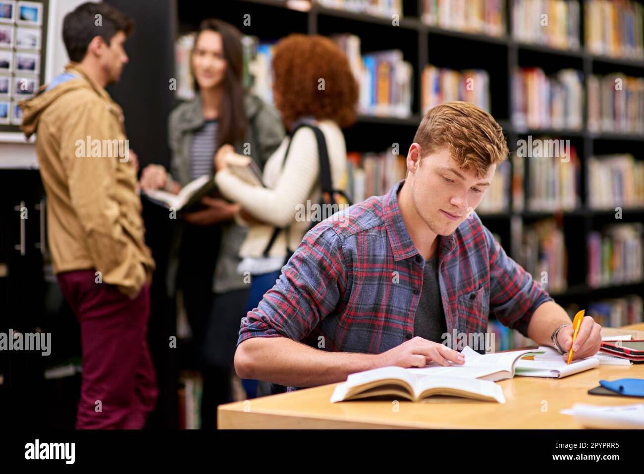 Hes got good study habits. a male student studying in a university ...