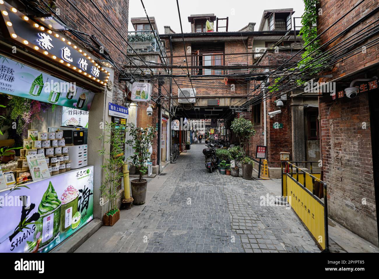 A picturesque alleyway featuring a vibrant sidewalk with street food ...