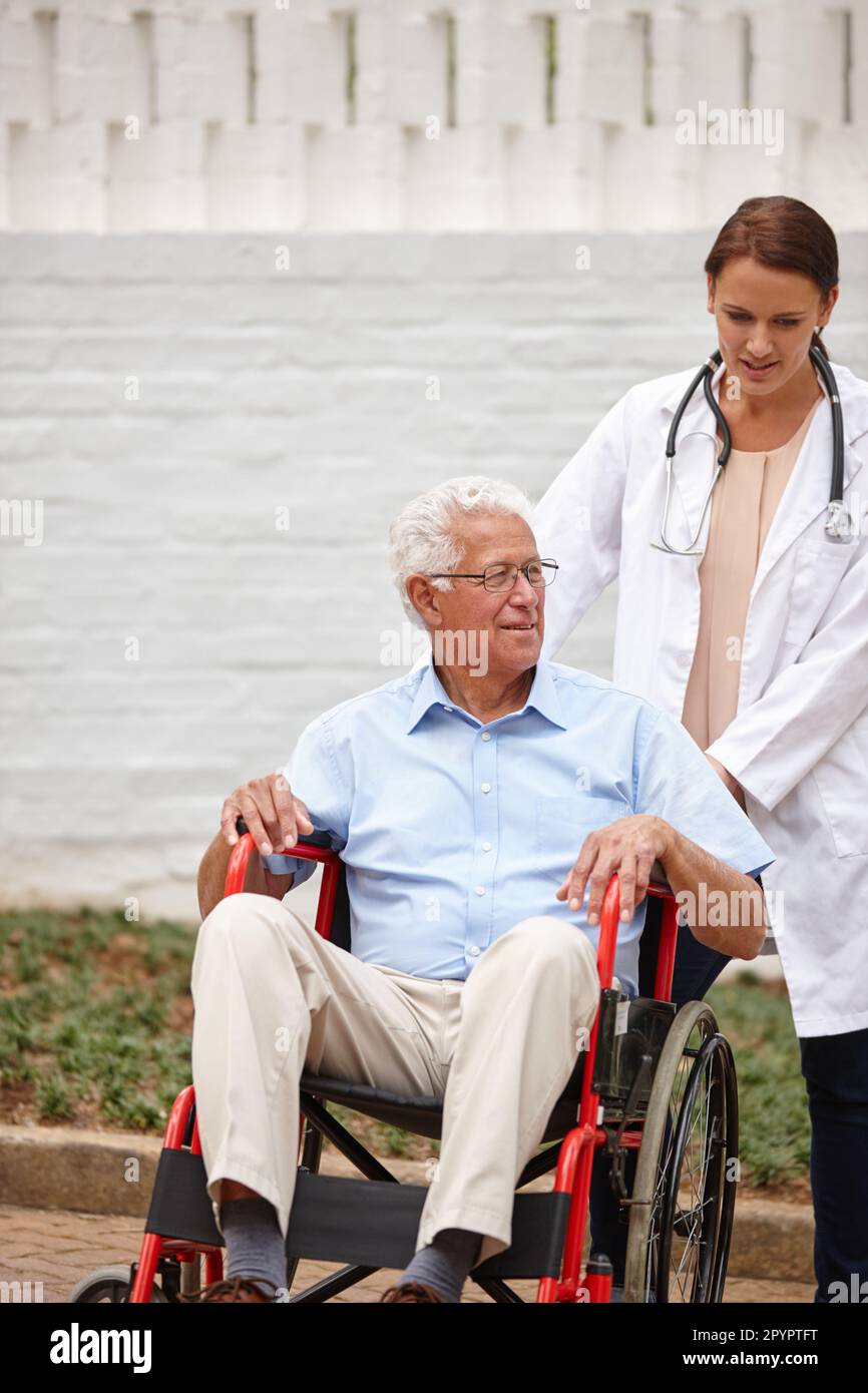 Where do you want to go. a female doctor pushing her senior patient in ...