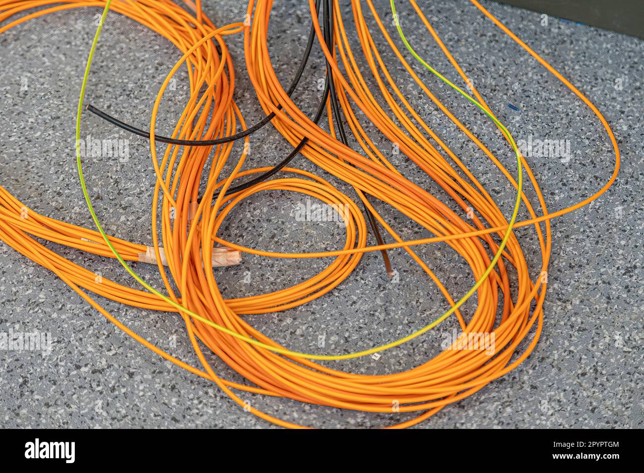 aorange electrical wires spread out on the ground Stock Photo - Alamy