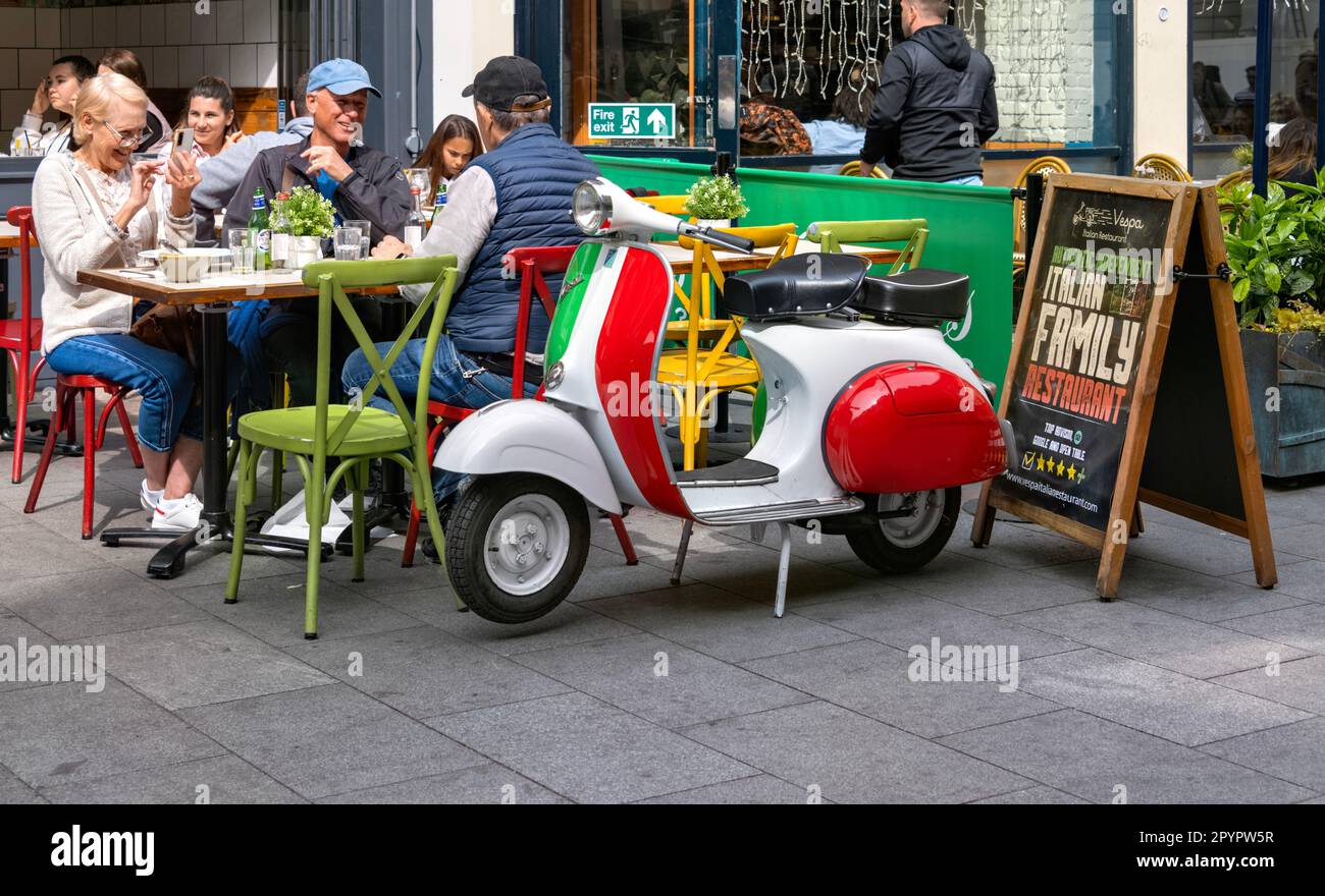 People sitting eating and drinking outside at the Vespa Italian ...