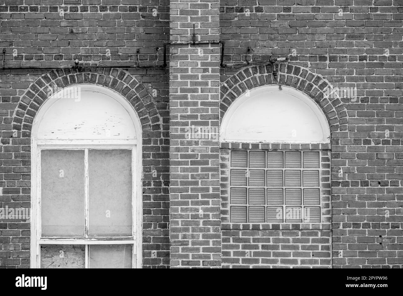 Boarded up windows in abandoned brick factory Stock Photo - Alamy
