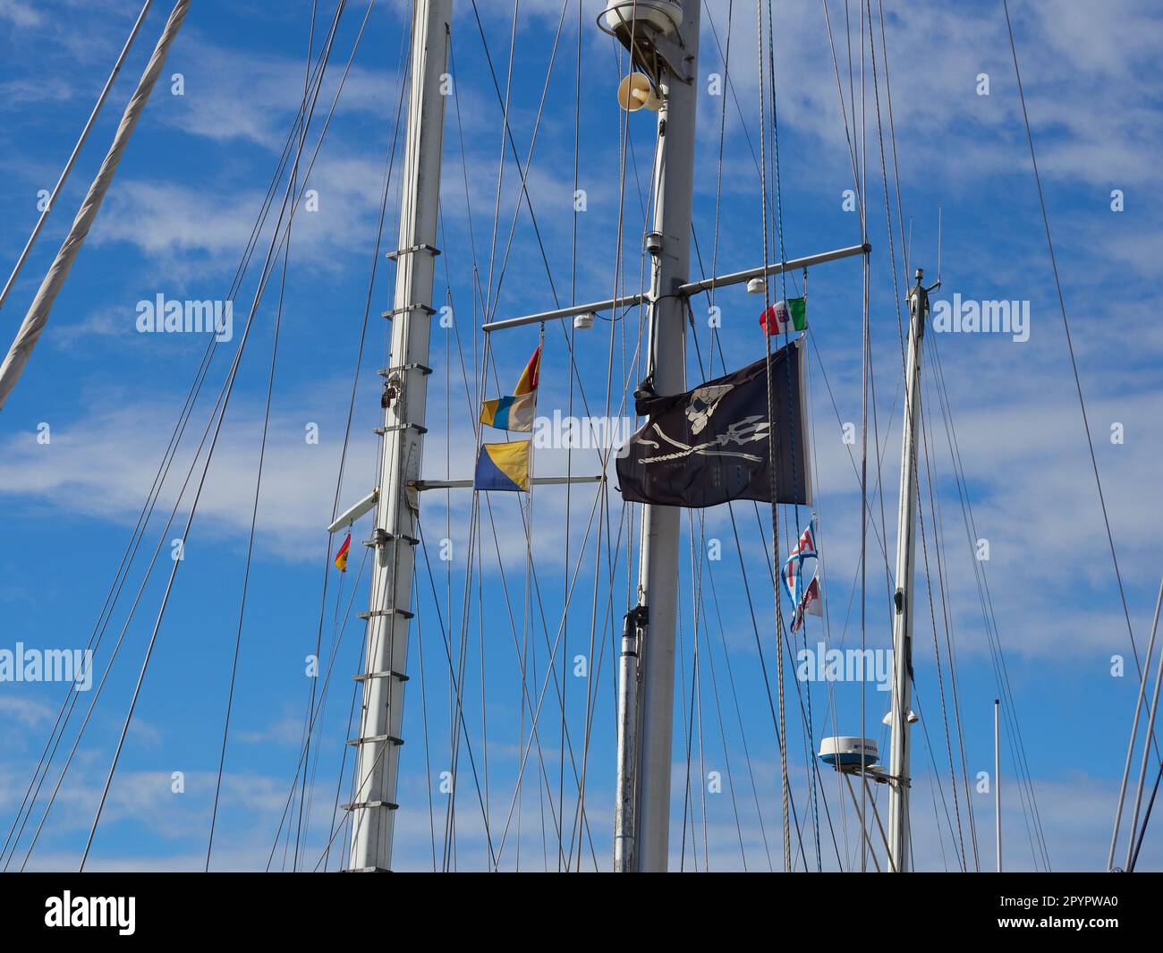 Sailing ship masts with flags and blue sky in the background Stock ...