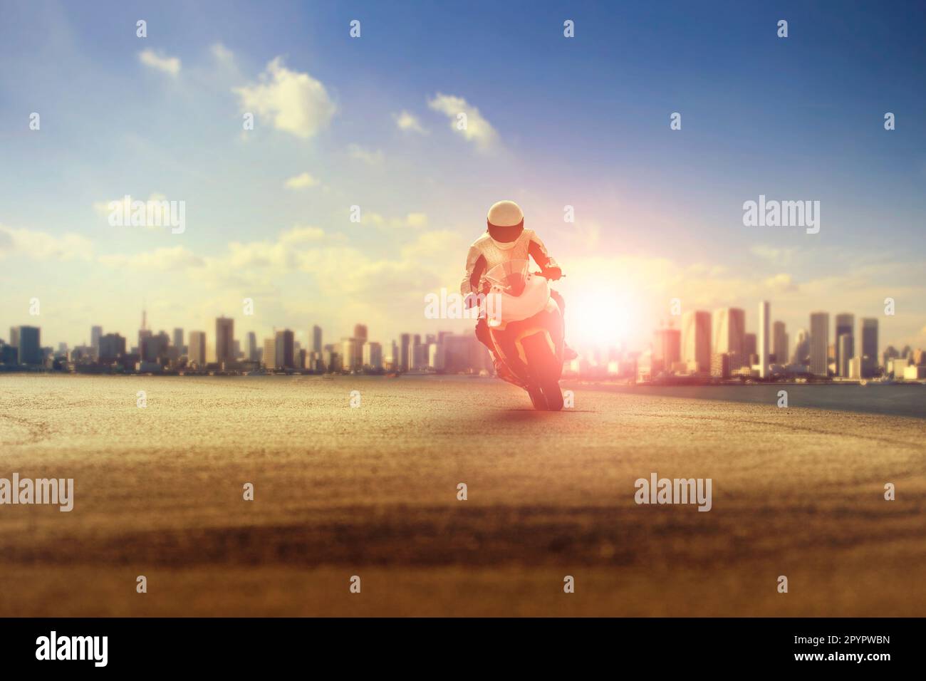 man riding big motorcycle on sharp curve against city building scene ...