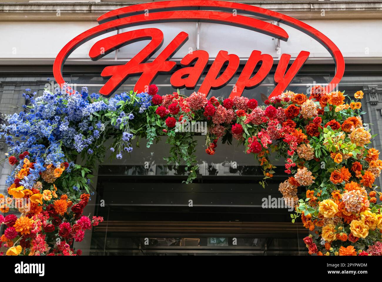 Front and Sign of Happy Restaurant adorned with flowers, Piccadilly ...