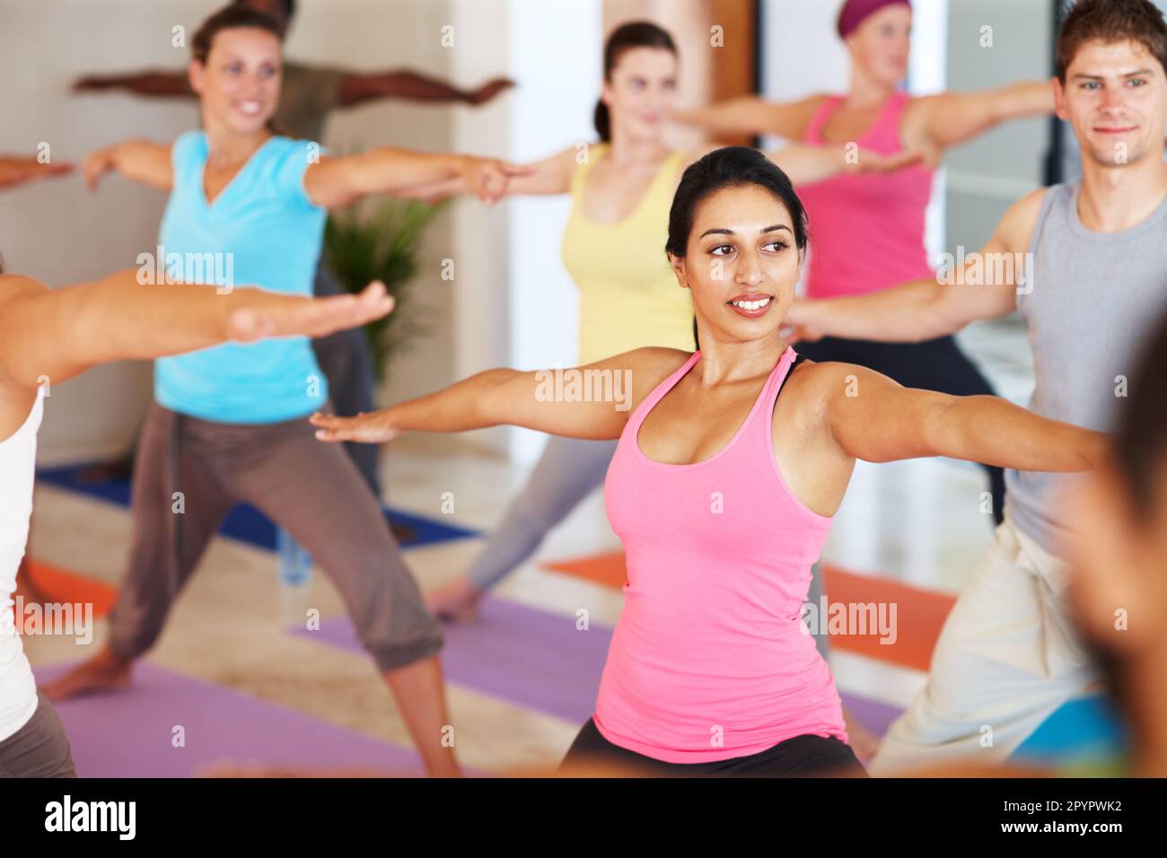 Improving posture and flexibility. A group of people doing a balancing ...