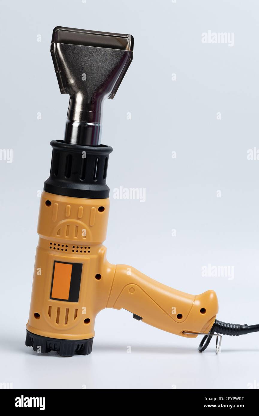 Yellow heat gun with metal head isolated on studio background Stock ...