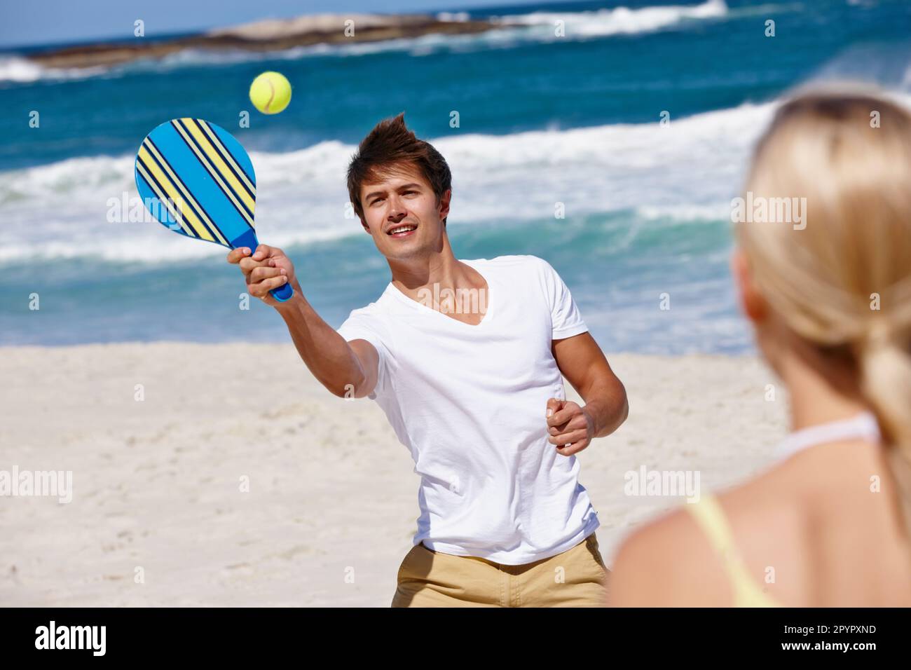 Keeping his eye on the ball. a happy young couple enjoying a game of ...