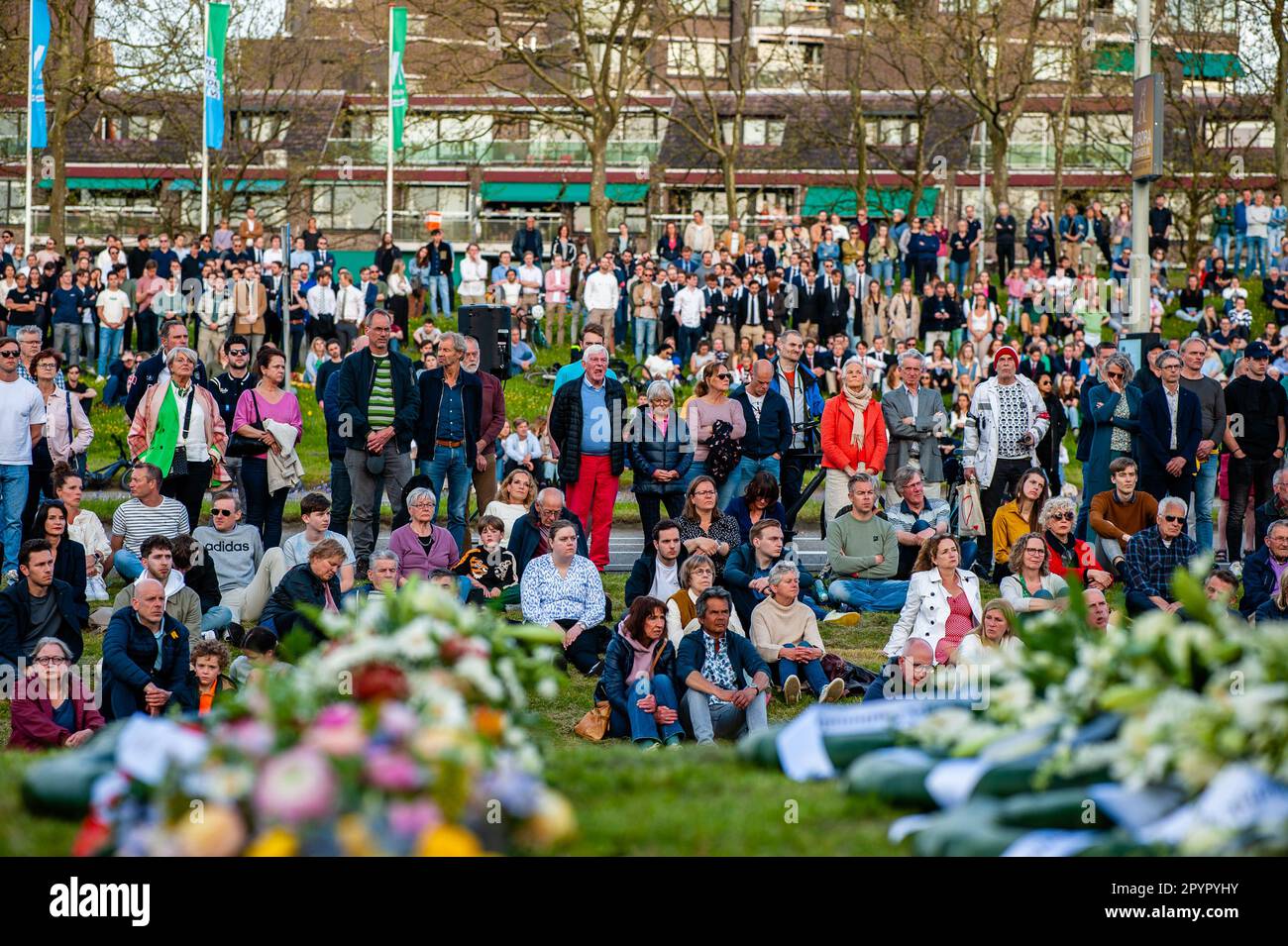 People seen standing on the grass as they take two minutes of silence ...