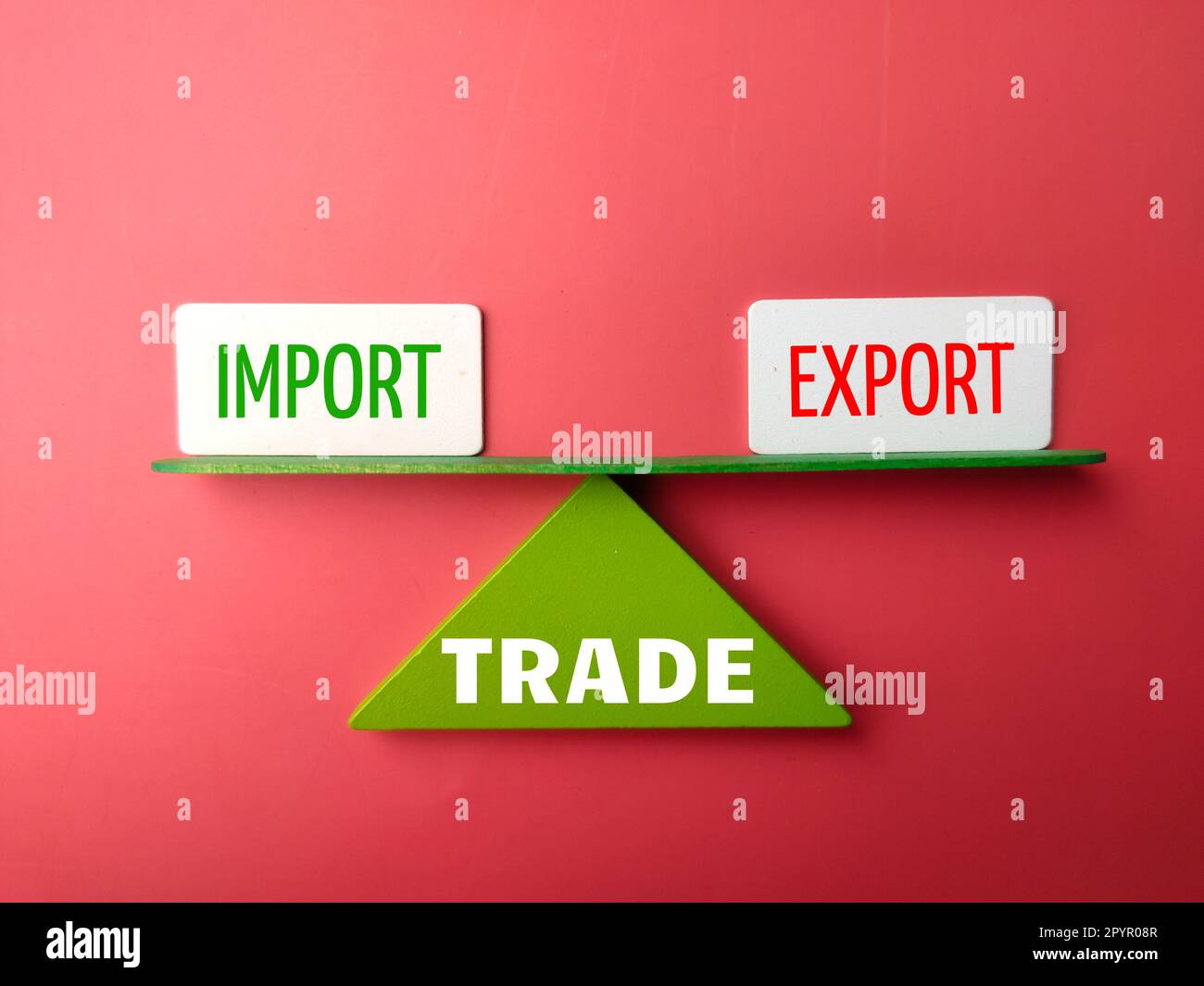 Wooden board with the word IMPORT EXPORT TRADE on a red background ...