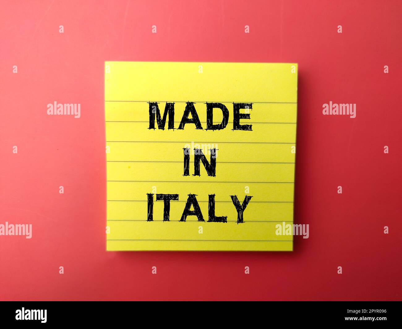 Yellow sticky note with the word MADE IN ITALY on a red background ...