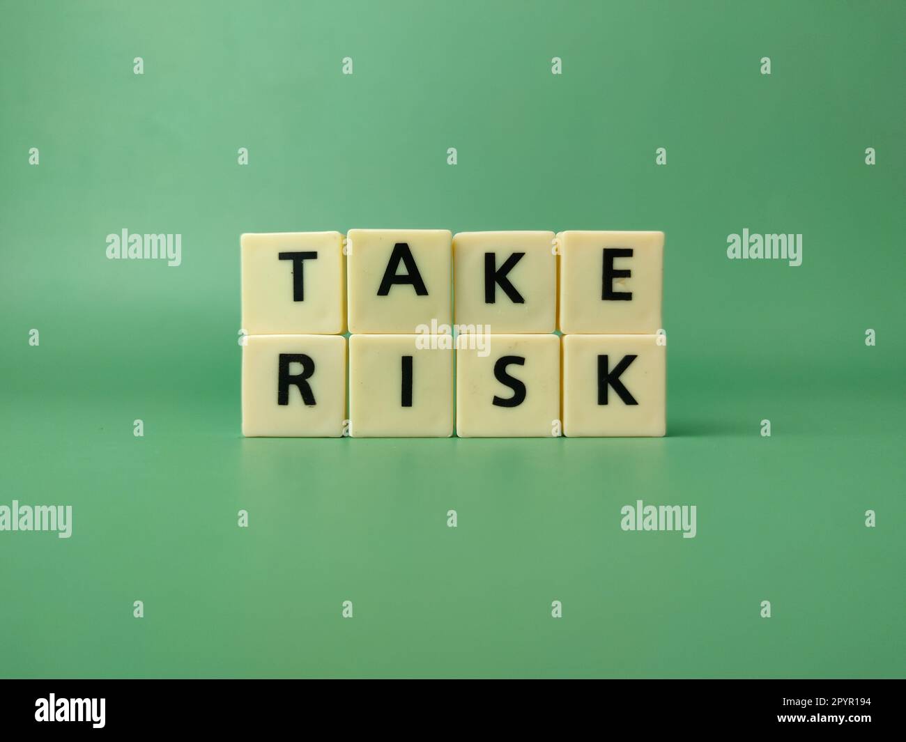 Toys word with the word TAKE RISK on a green background Stock Photo - Alamy