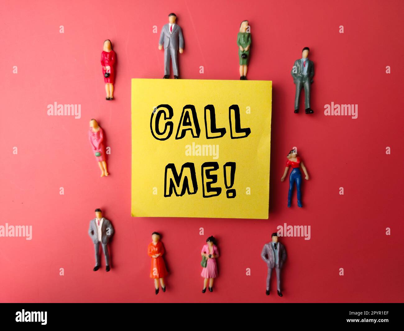 Sticky note and miniature people with the word CALL ME on red ...