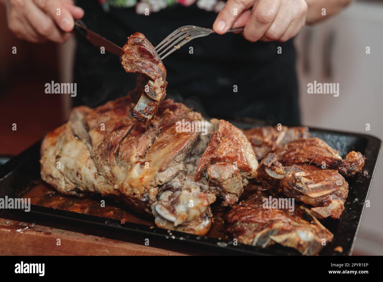 Intimate Views of Skilled Hands Carving Juicy Lamb Roast in The Kitchen ...