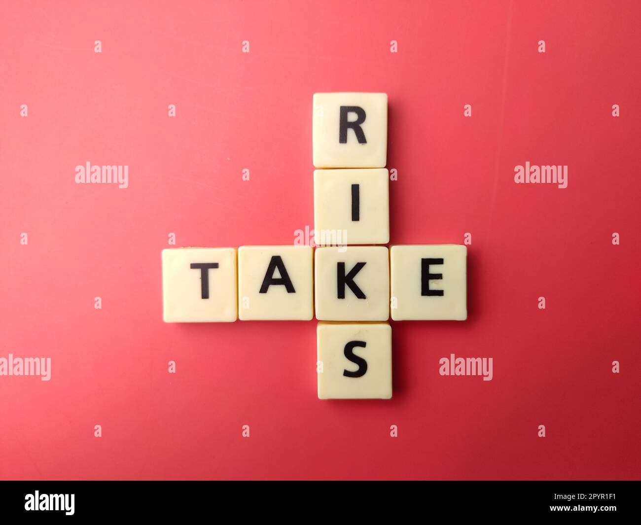 Toys word with the word TAKE RISK on a red background Stock Photo - Alamy