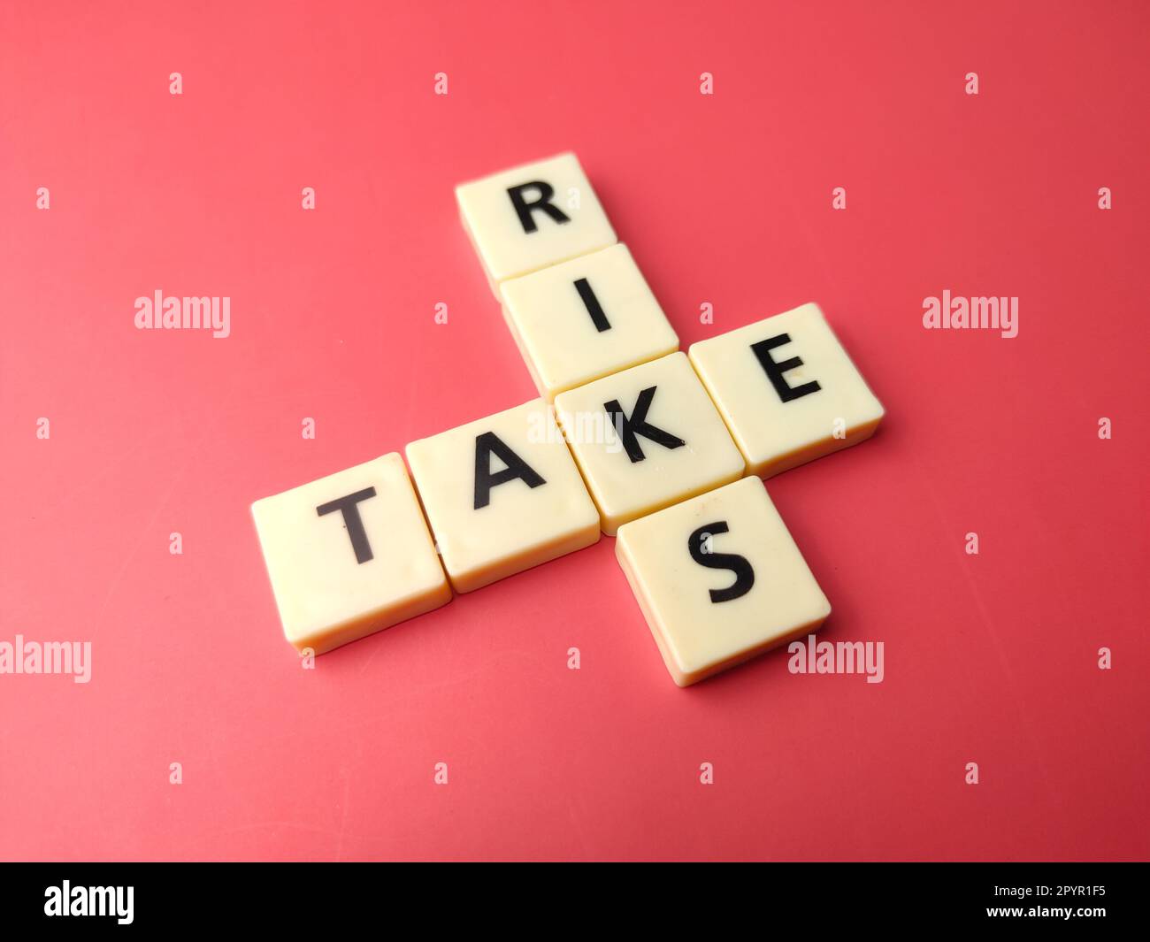 Toys word with the word TAKE RISK on a red background Stock Photo - Alamy