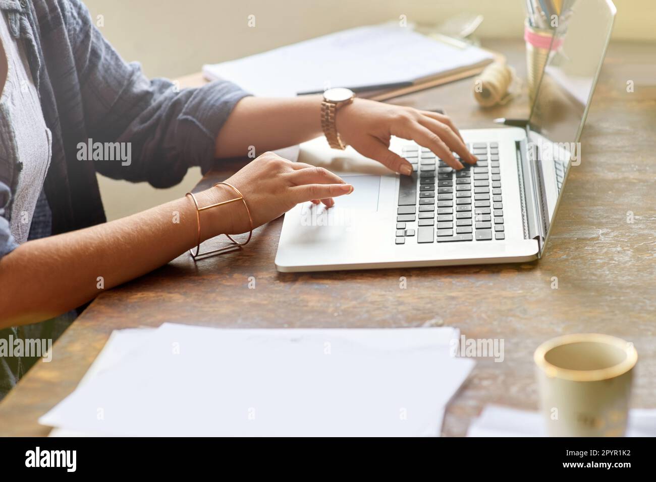 In the creative zone. a young graphic designer working on her laptop at ...