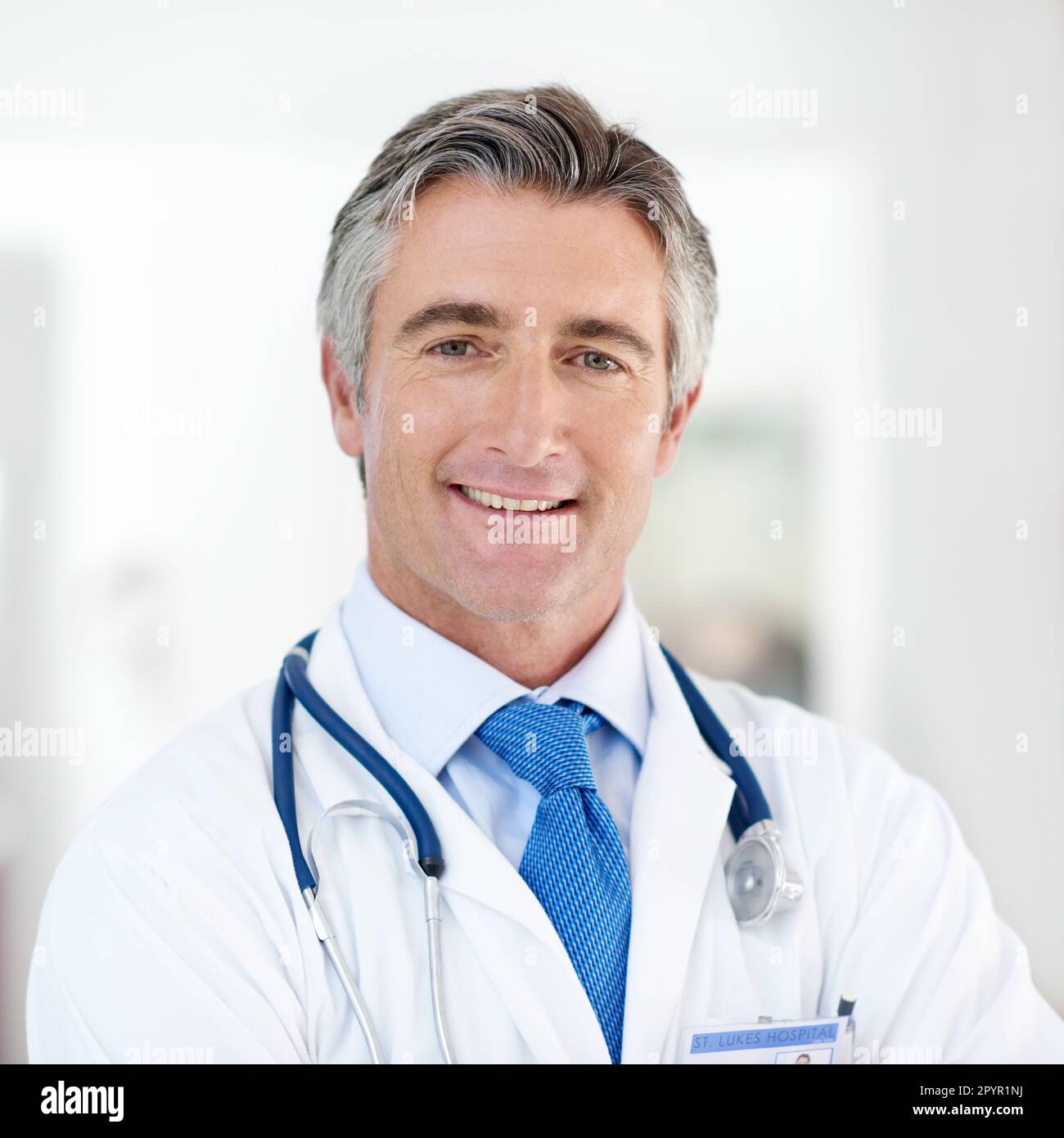 Health matters. Portrait of a male doctor standing in a hospital ...