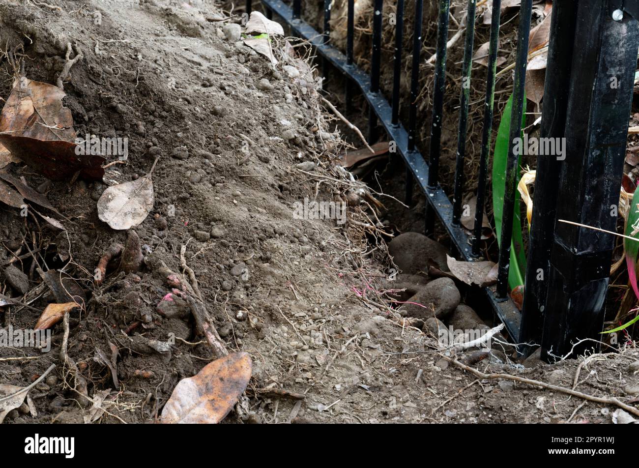 A metal steel fence is being constructed, a ditch has been dug for it ...