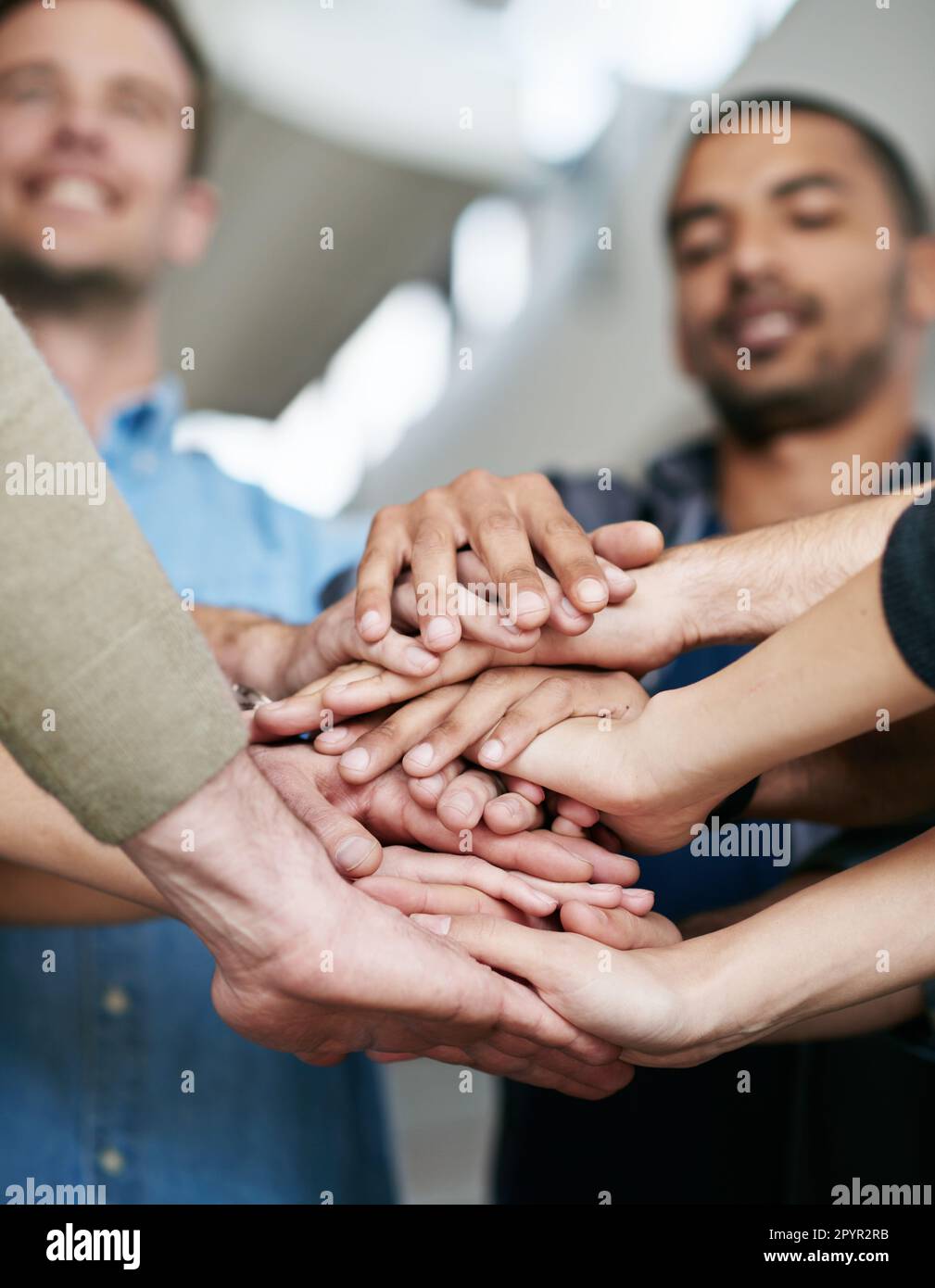 Bring it in for the team. Cropped view of a multi ethnic group putting ...