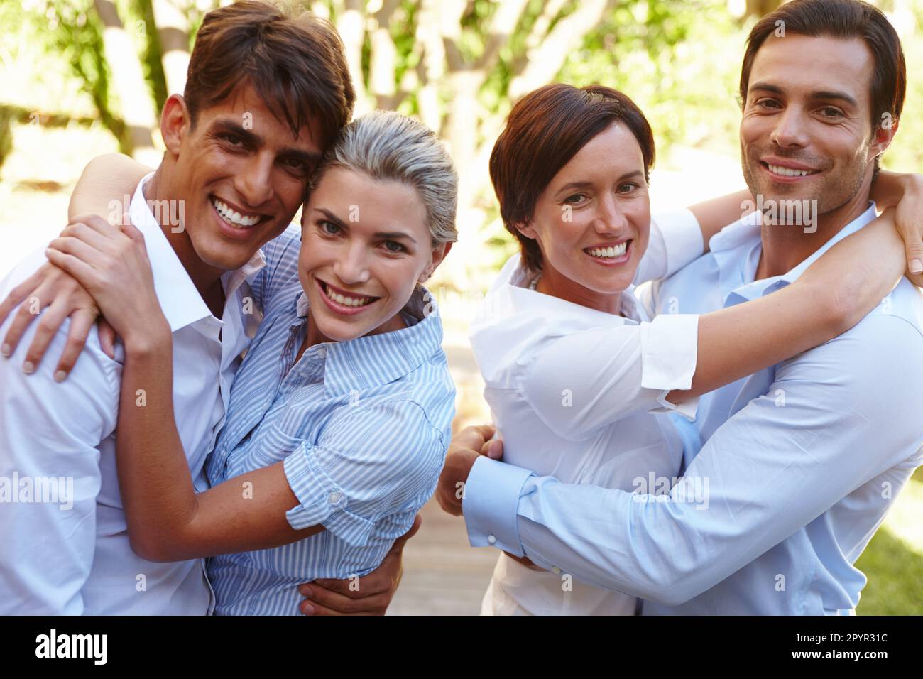 Couples retreat. two happy young couples standing together outside ...