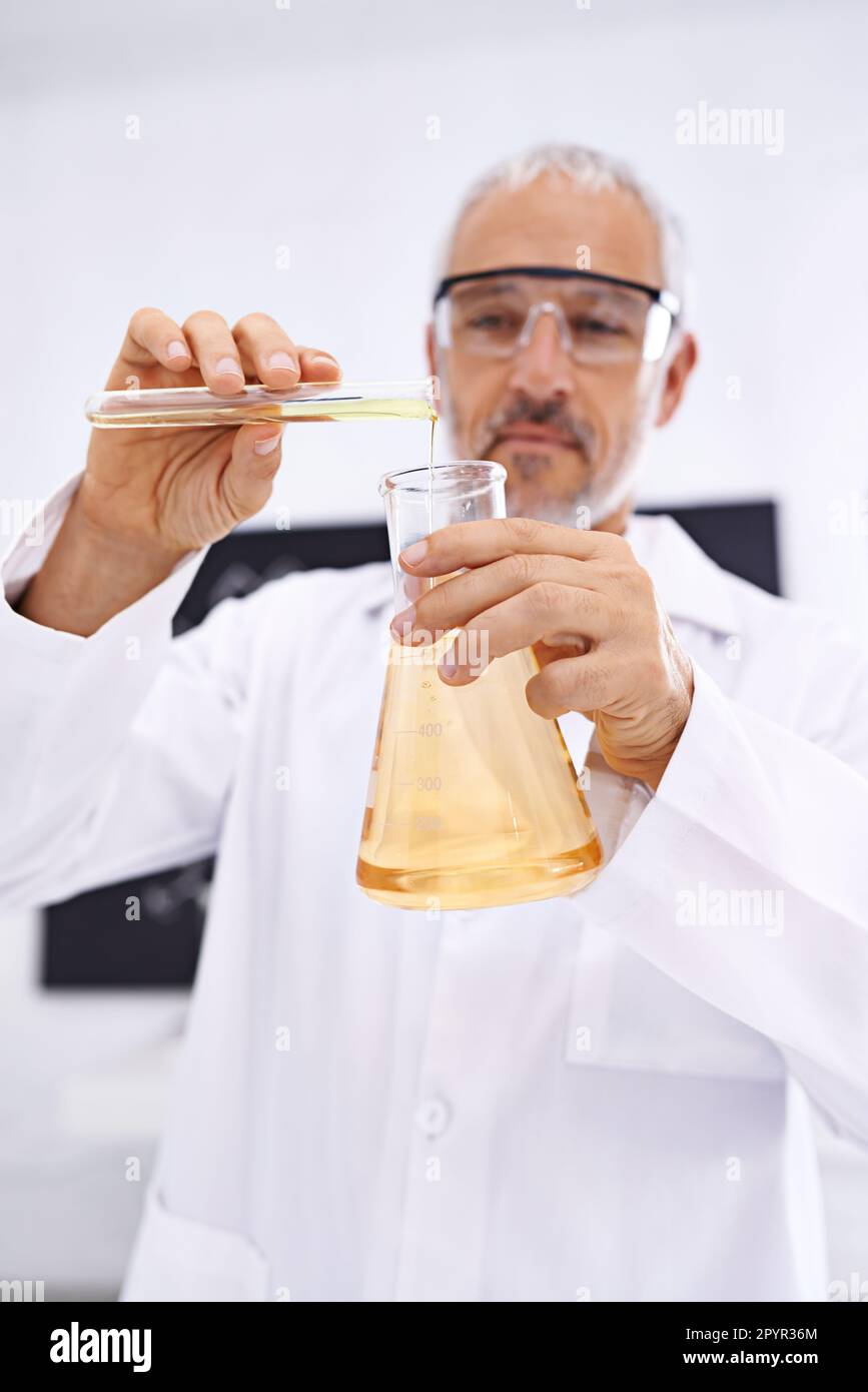 You might want to step back...a mature male scientist conducting an experiment in his lab Stock ...