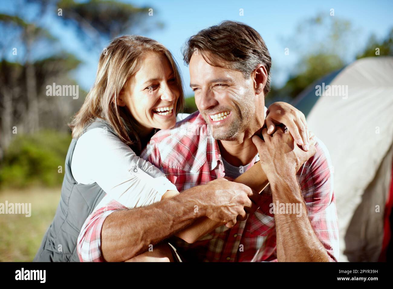 Feeling free and in love in the wilderness. A loving young couple ...