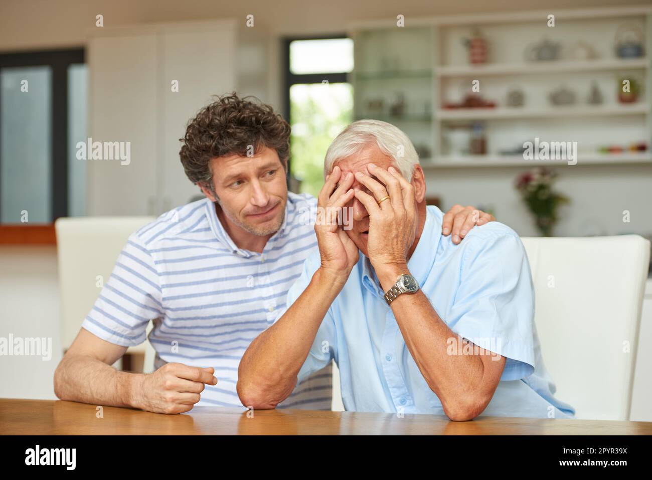 Youll get through this. a man consoling his senior father at home Stock ...