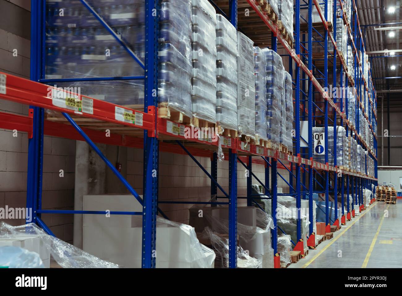 Warehouse interior with metal racks full of merchandise. Wholesale ...