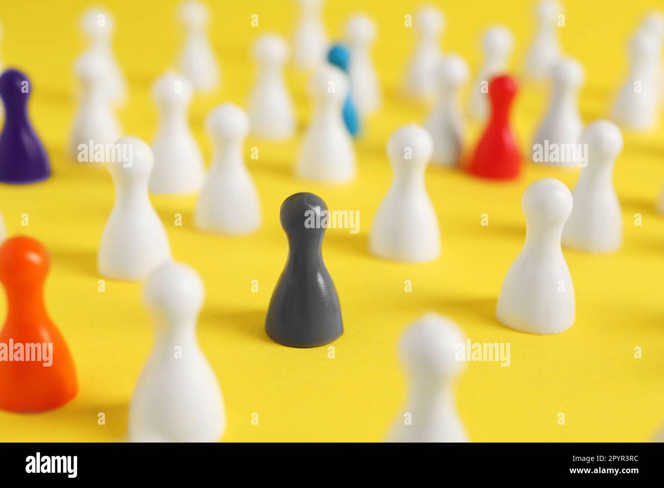 Colorful pawns on yellow background, closeup. Social inclusion concept ...