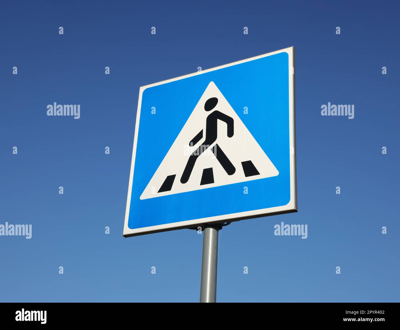 traffic sign Pedestrian Crossing against blue sky, low angle view Stock ...