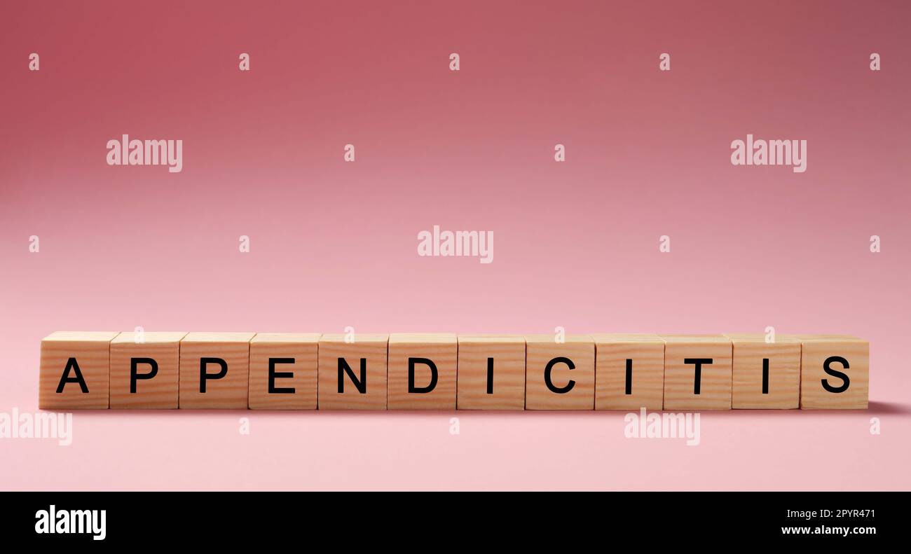 Word Appendicitis made of wooden cubes with letters on pink background ...