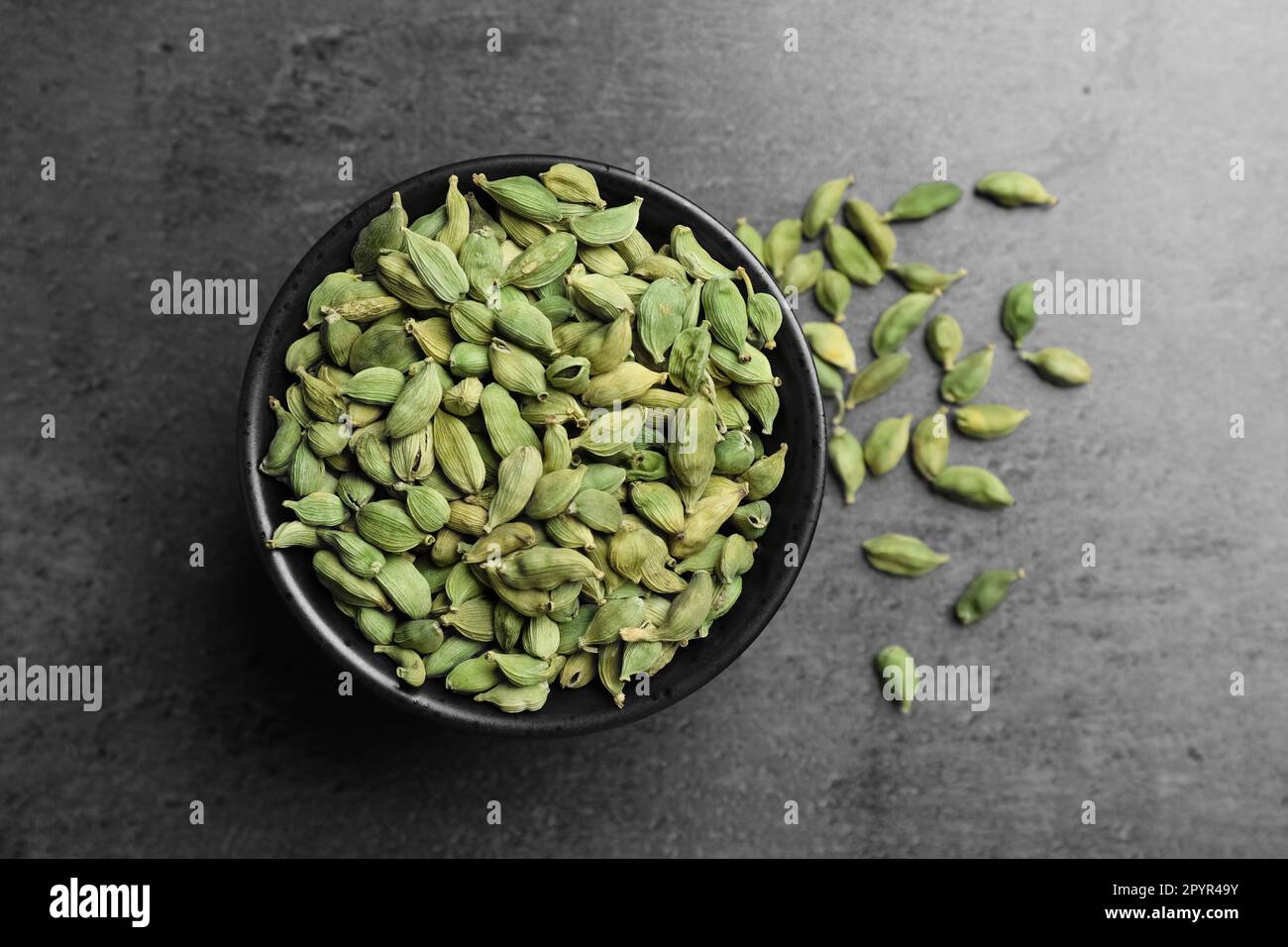 Bowl of dry cardamom pods on dark grey table, top view Stock Photo - Alamy