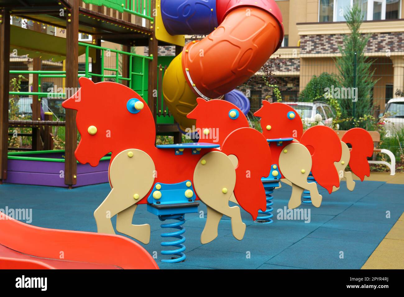 Colourful spring horse on outdoor playground in residential area Stock ...